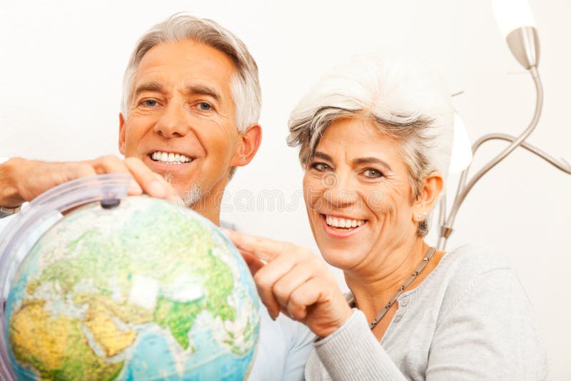 Senior Couple Planning a World Tour Stock Photo - Image of world, happy ...