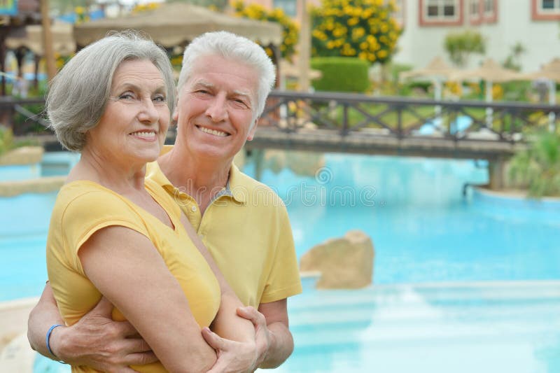 Senior Couple by Pool at the Resort Stock Photo - Image of female, face ...