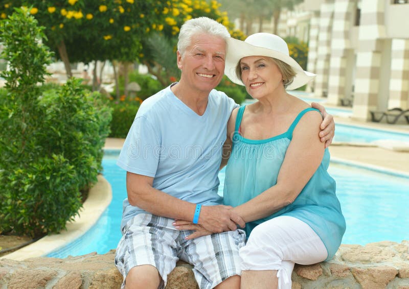 Senior couple by pool stock photo. Image of health, look - 44346422