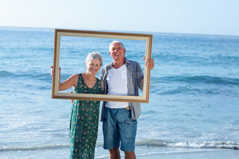 Senior Couple Posing with a Frame Stock Image - Image of closeness ...