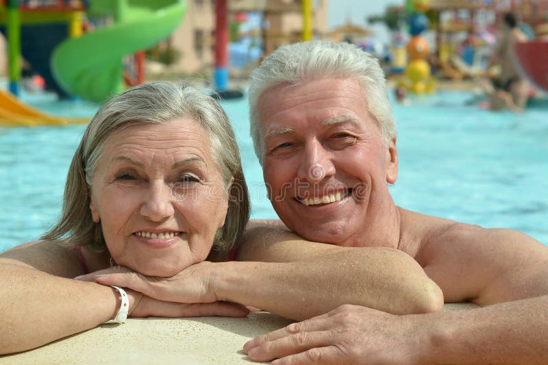 Senior Couple Relaxing at Pool Stock Photo - Image of leisure, natural ...