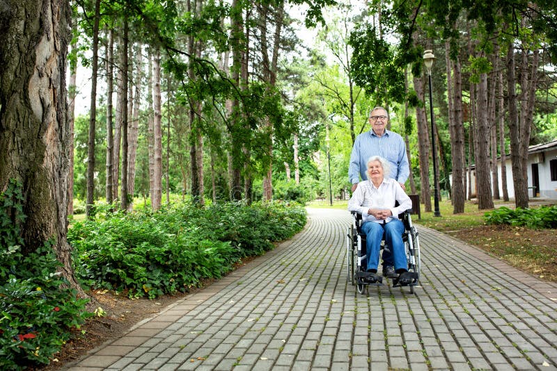 Senior Couple Rolling and Strolling in the Park Stock Image - Image of ...