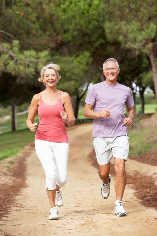 Senior Couple Running in Park Stock Image - Image of seniors, park ...