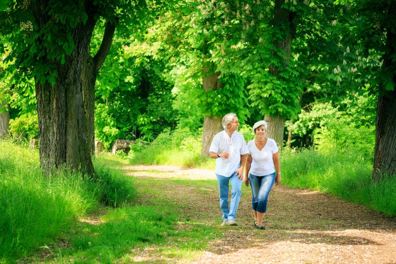 Senior Couple Taking a Walk Stock Photo - Image of couple, horizontal ...