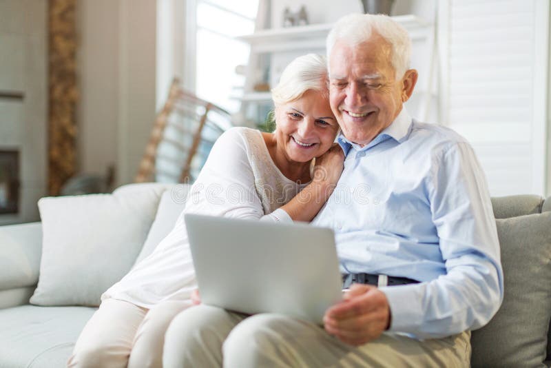Senior Couple Using Laptop Computer at Home Stock Image - Image of ...