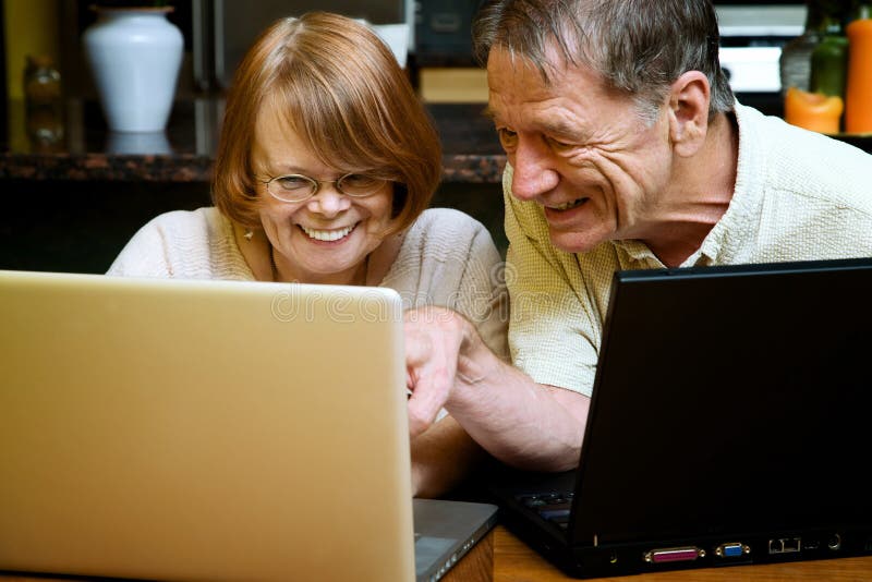 Senior Couple Using Laptop Computers at Home Stock Image - Image of ...