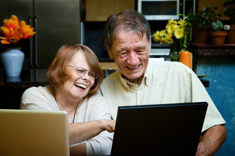Senior Couple Using Laptop Computers at Home Stock Photo - Image of ...