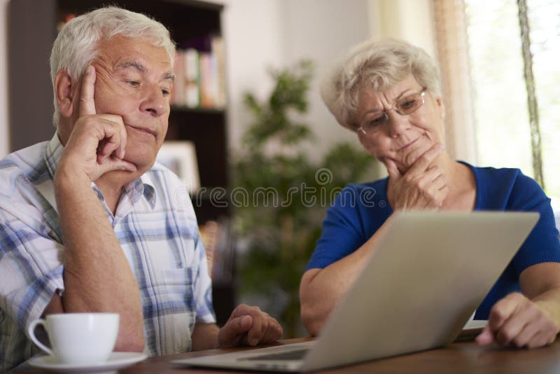 Senior couple using laptop stock photo. Image of couple - 58787300
