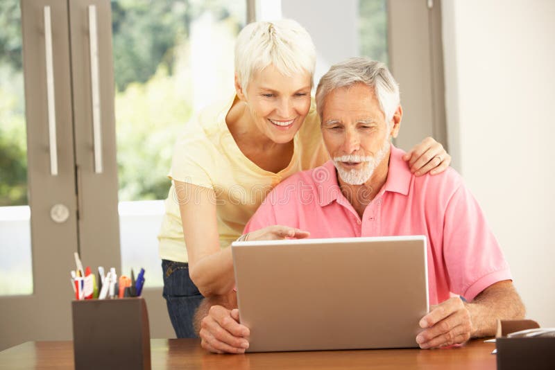 Senior Middle Aged Happy Couple Embracing Using Laptop Together Stock ...