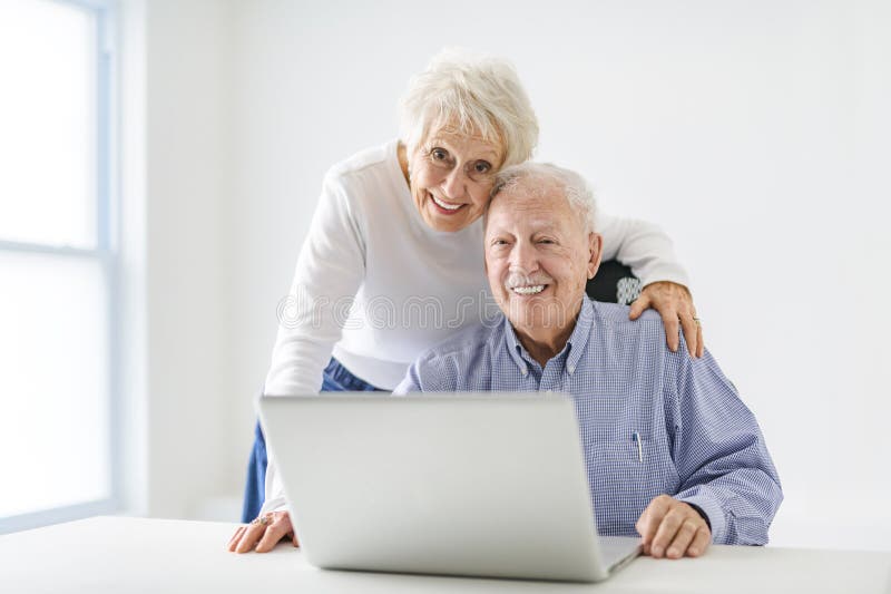 Senior Couple Using a Laptop while Sitting at the Office Stock Image ...