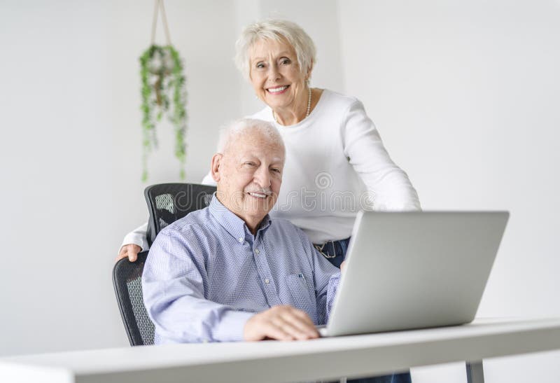 Senior Couple Using a Laptop while Sitting at the Office Stock Image ...