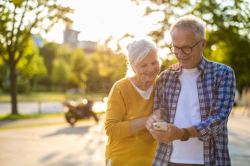 Senior Couple Using Smartphone in the City Stock Image - Image of ...