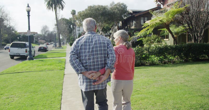 Senior Couple Walking through Neighborhood Stock Video - Video of ...