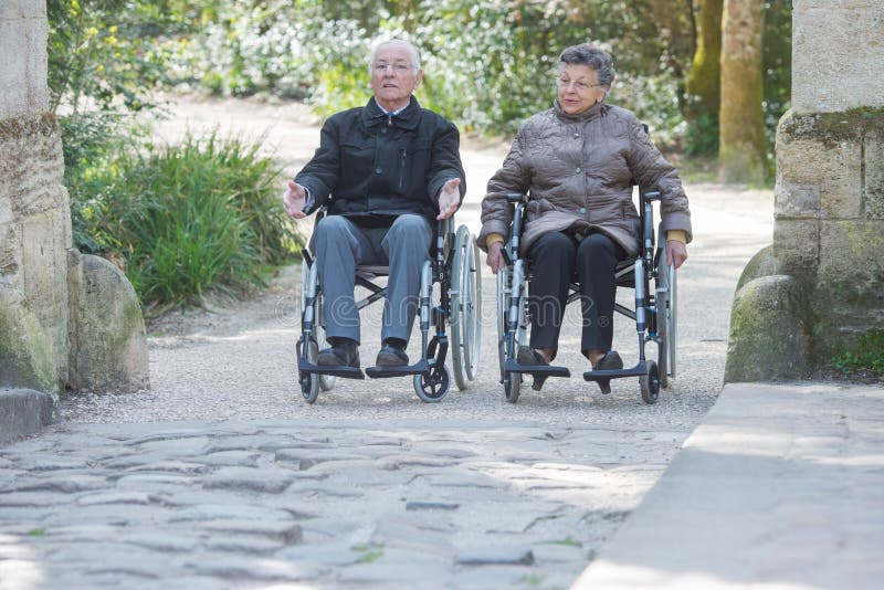 Senior Couple Wandering on Their Wheelchairs Stock Photo - Image of ...