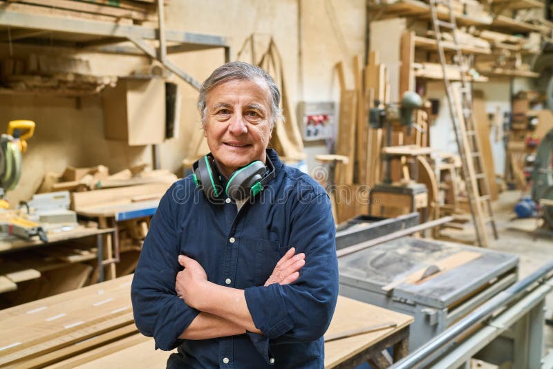 Senior Craftsman Standing in a Busy Lumberyard Workshop Setting Stock ...