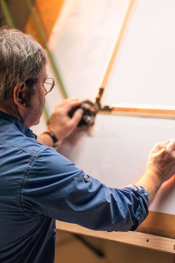 The Mature Creative Engineer Working with Project on Drawing Board ...