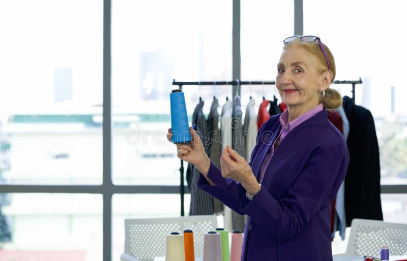 Senior Designer Pulling Yarn from Thread Spool, Prepared for Tailoring ...
