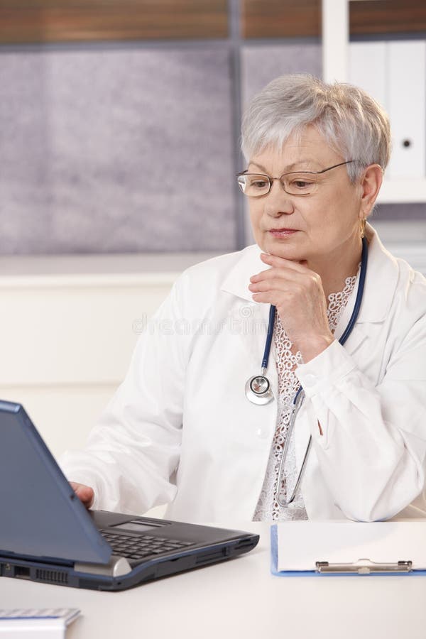 Senior Doctor Looking at Computer Stock Image - Image of female ...