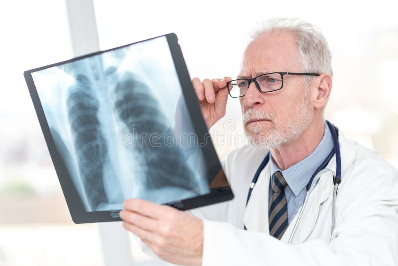 Senior Doctor Looking at X-ray Stock Image - Image of radiography ...
