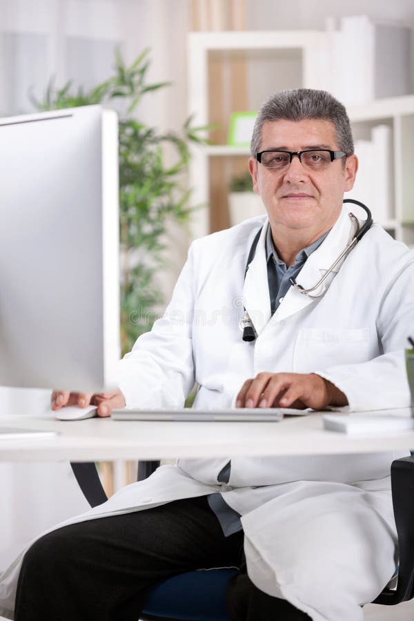 Senior Doctor in the Office Working on the Computer Stock Image - Image ...