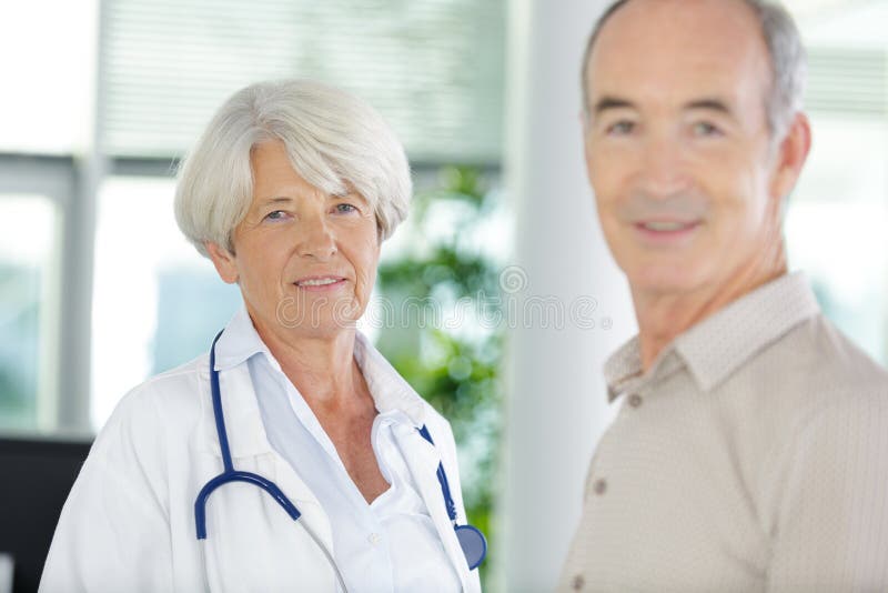 Senior Doctor and Patient Looking at Camera Stock Photo - Image of ...