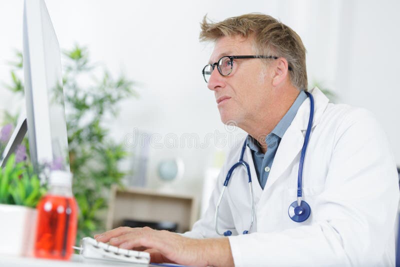 Senior Doctor with Pc at Office Desk Stock Image - Image of hospital ...