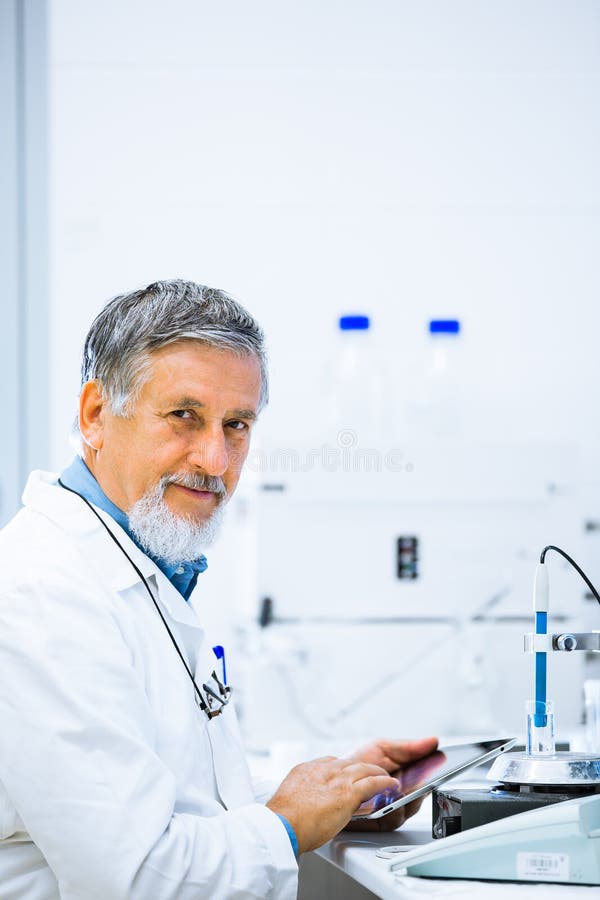 Senior Doctor/scientist Using His Tablet Computer at Work Stock Photo ...