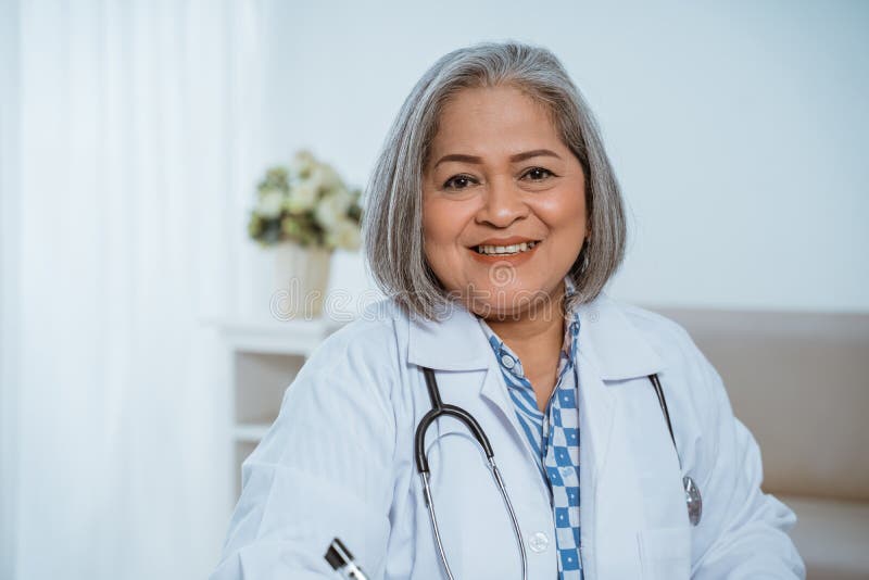 The Senior Doctor Smiled Wearing a Uniform Stock Photo - Image of ...