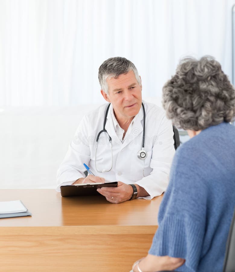 A Senior Doctor Talking with His Patient Stock Photo - Image of ...