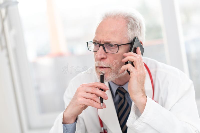 Senior Doctor Talking on Mobile Phone Stock Image - Image of ...