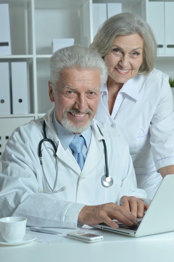 Senior Doctors with laptop stock photo. Image of lifestyle - 68614478