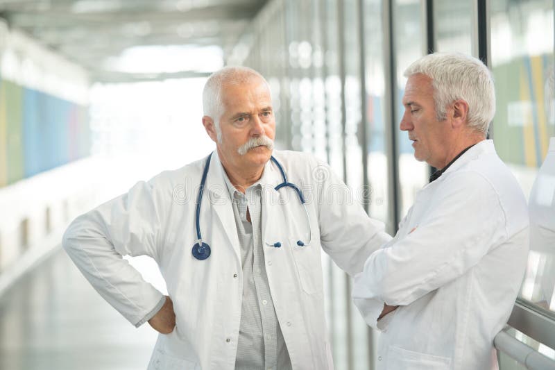 Senior Doctors Talking in Hospital Stock Photo - Image of uniform ...
