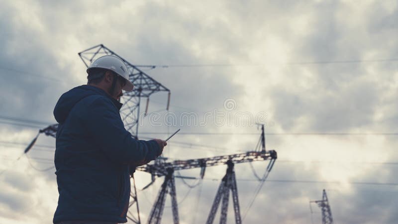 Senior Electrical Engineer Working with Tablet Near Electrical Lines ...