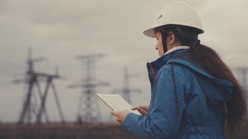 Senior Electrical Engineer Working with Tablet Near Electrical Lines ...