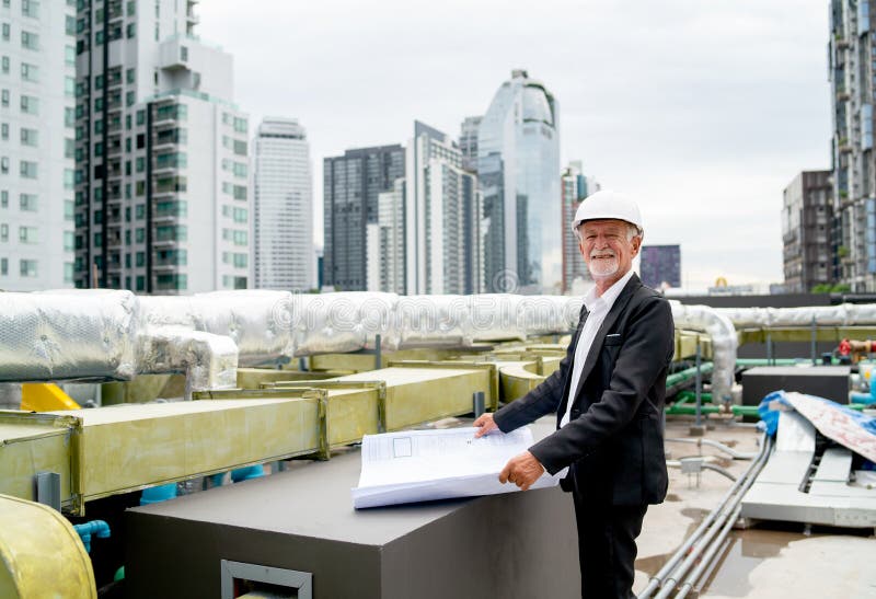 Senior Engineer Man Stand in Front of Line of Air Vents and Also Using ...