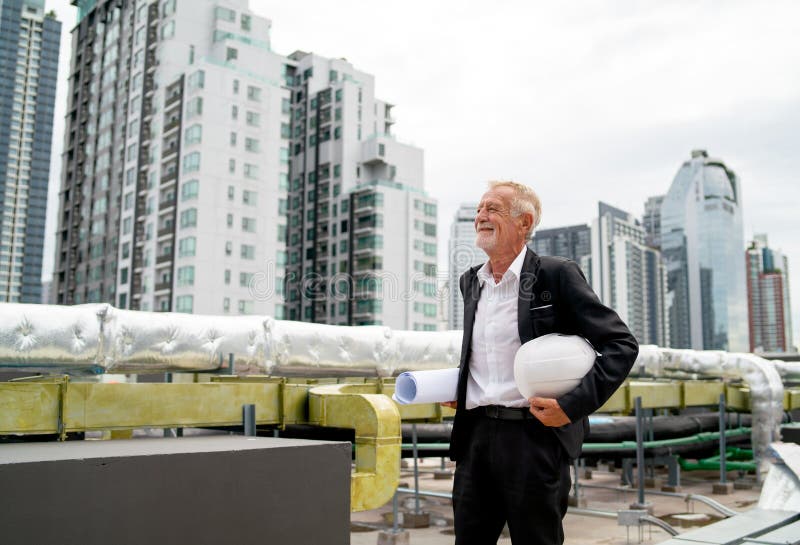 Senior Engineer Man or Technician Worker Hold Building Plan or Drawing ...