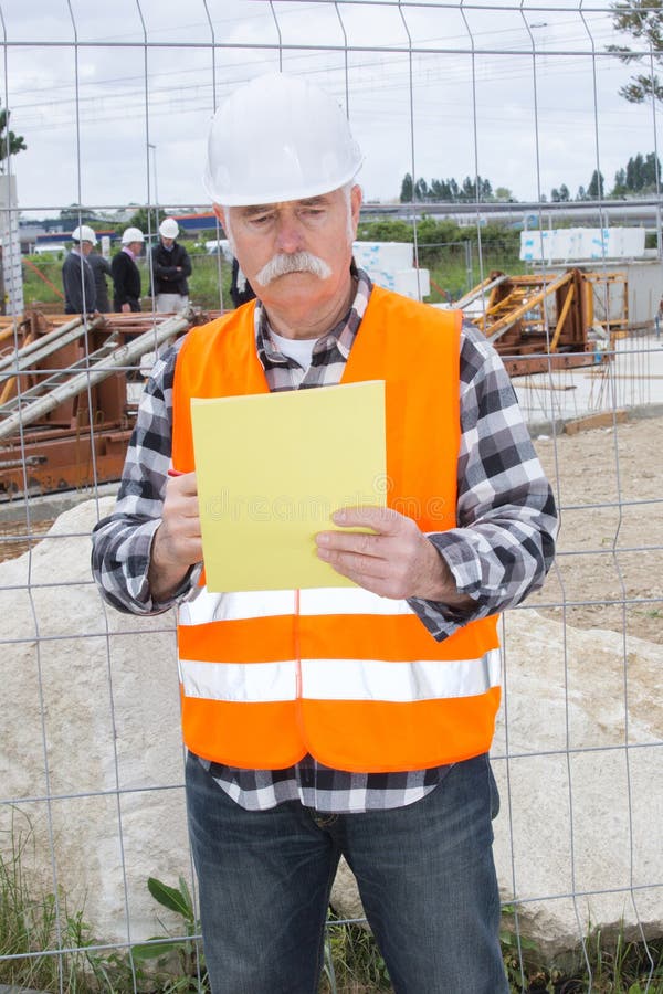 Senior Engineer Reading Document Outdoors Stock Photo - Image of ...