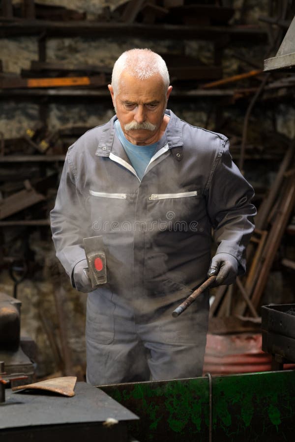 Senior Factory Worker Using Hammer Stock Image - Image of engineer ...