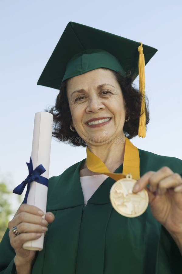 Senior Female Graduate Holding Certificate and Medal Stock Photo ...