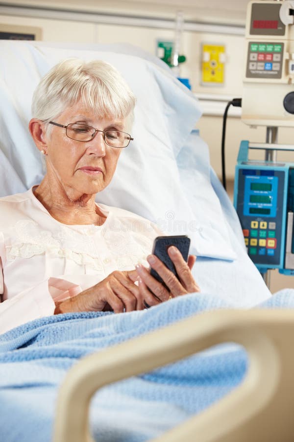 Senior Female Patient in Hospital Bed Using Mobile Phone Stock Photo ...