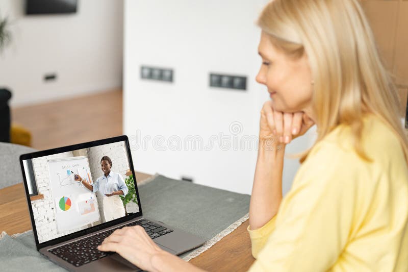 Senior Female Working or Studies Online. Mature Woman is Watching ...