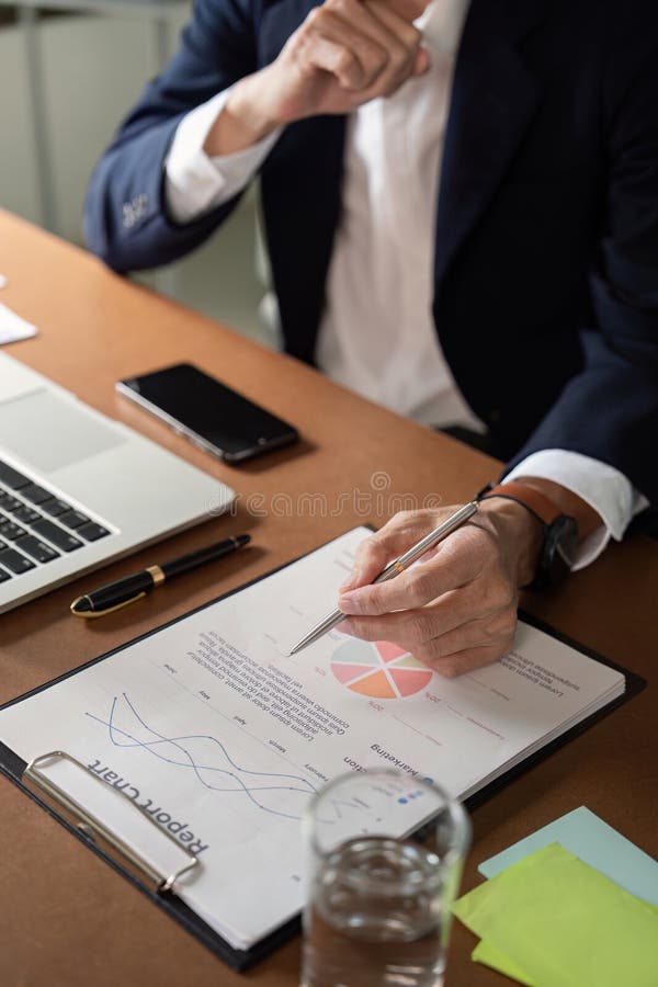 Senior Financial Analyst Preparing Report with Charts and Graphs in ...