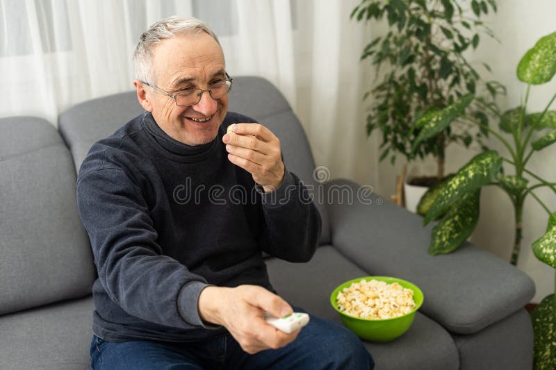 Senior Gentleman Sitting on a Sofa and Watching TV. Stock Image - Image ...