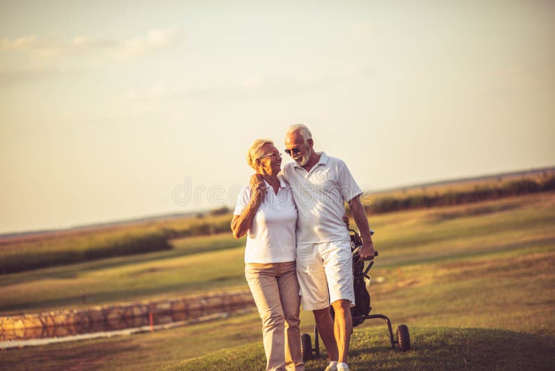Golfers Talking and Walking on Golf Course Stock Photo - Image of ...