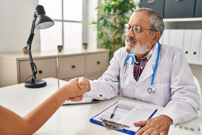 Senior Grey-haired Man Doctor and Patient Shake Hands at Clinic Stock ...