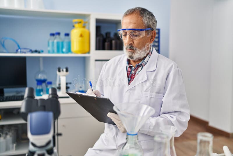 Senior Grey-haired Man Scientist Writing Report Working at Laboratory ...