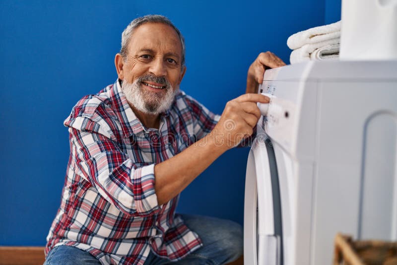 Senior Grey-haired Man Smiling Confident Turning on Washing Machine at ...