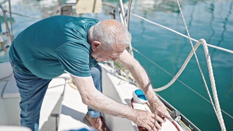 Senior Grey-haired Man Smiling Confident Tying Boat Rope at Boat Stock ... Senior Grey-haired Man Smiling Confident Tying Boat Rope at Boat Stock ...