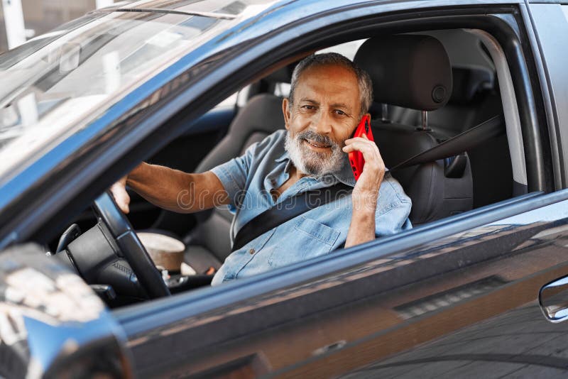 Senior Grey-haired Man Talking on Smartphone Sitting on Car at Street ...
