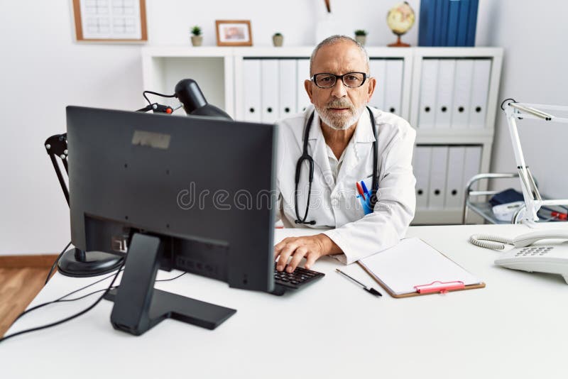 Senior Grey-haired Man Wearing Doctor Uniform Working at Clinic Stock ...